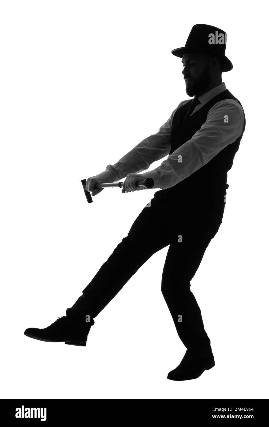 Silhouette of male magician dancing with stick on white background ...