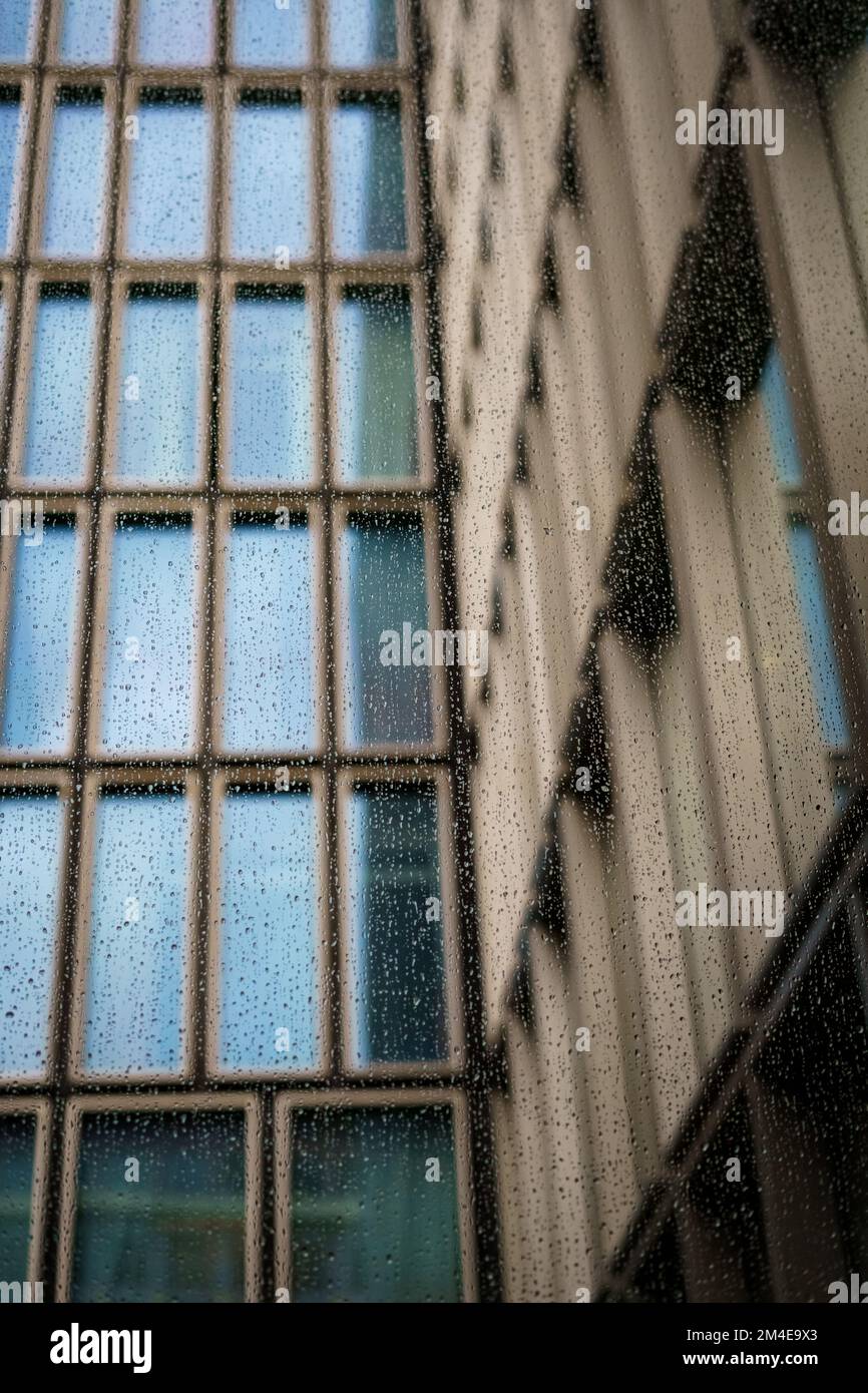 A low angle of Raindrops on a window of the office building Stock Photo ...