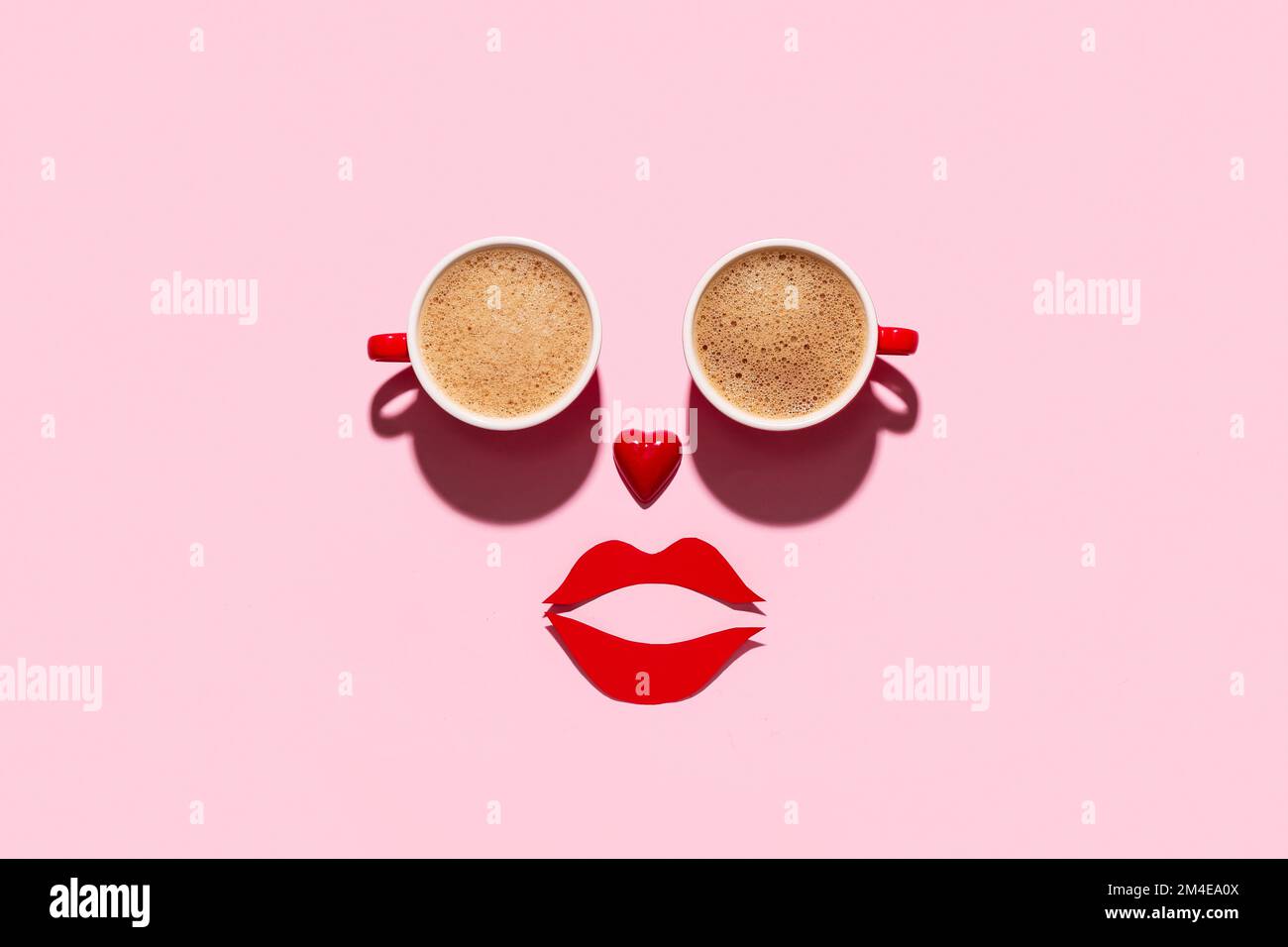 Face made of coffee cups, heart and paper lips on pink background ...