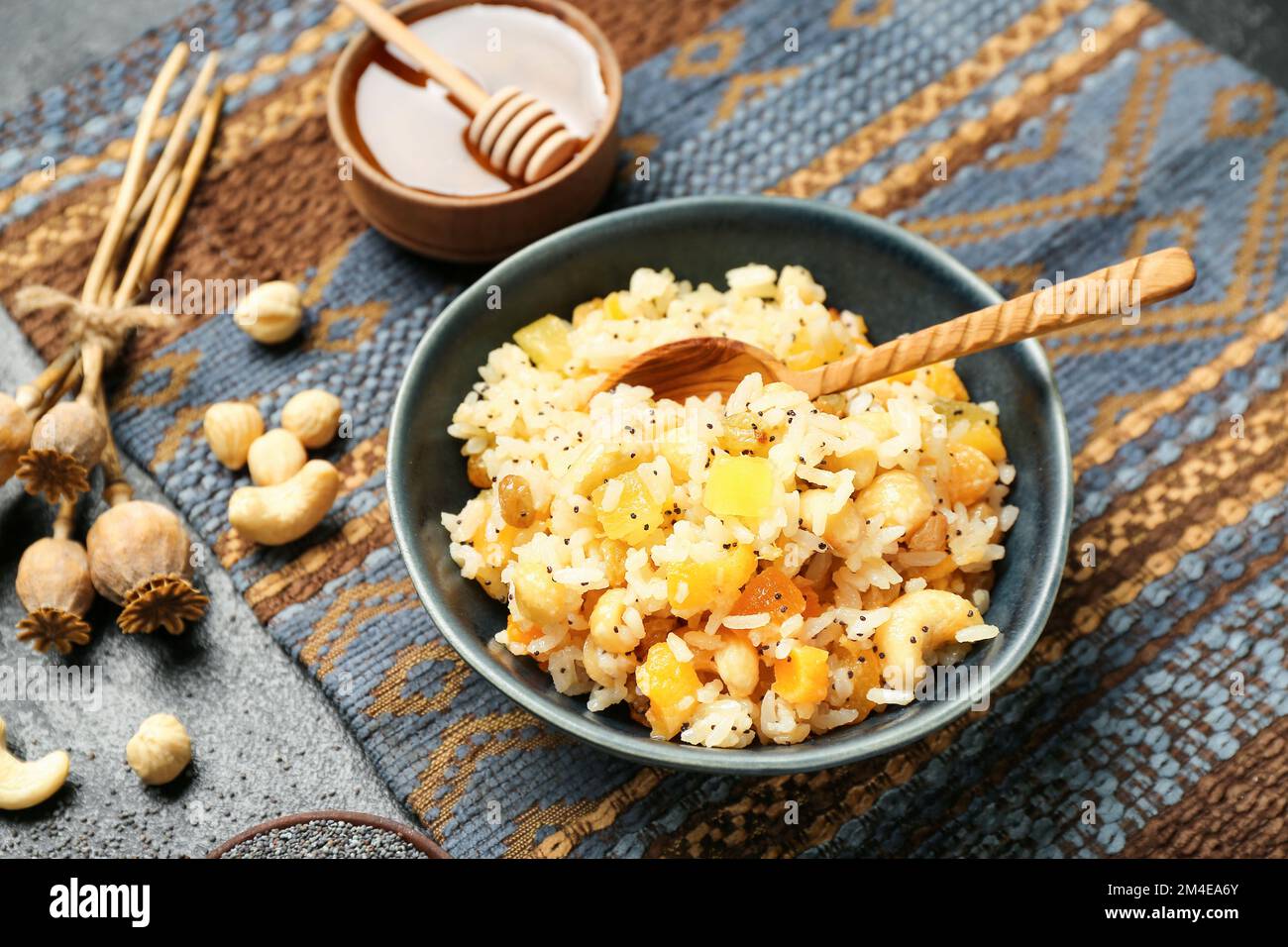 Bowl of rice Kutya, ingredients and poppy pods on dark background ...