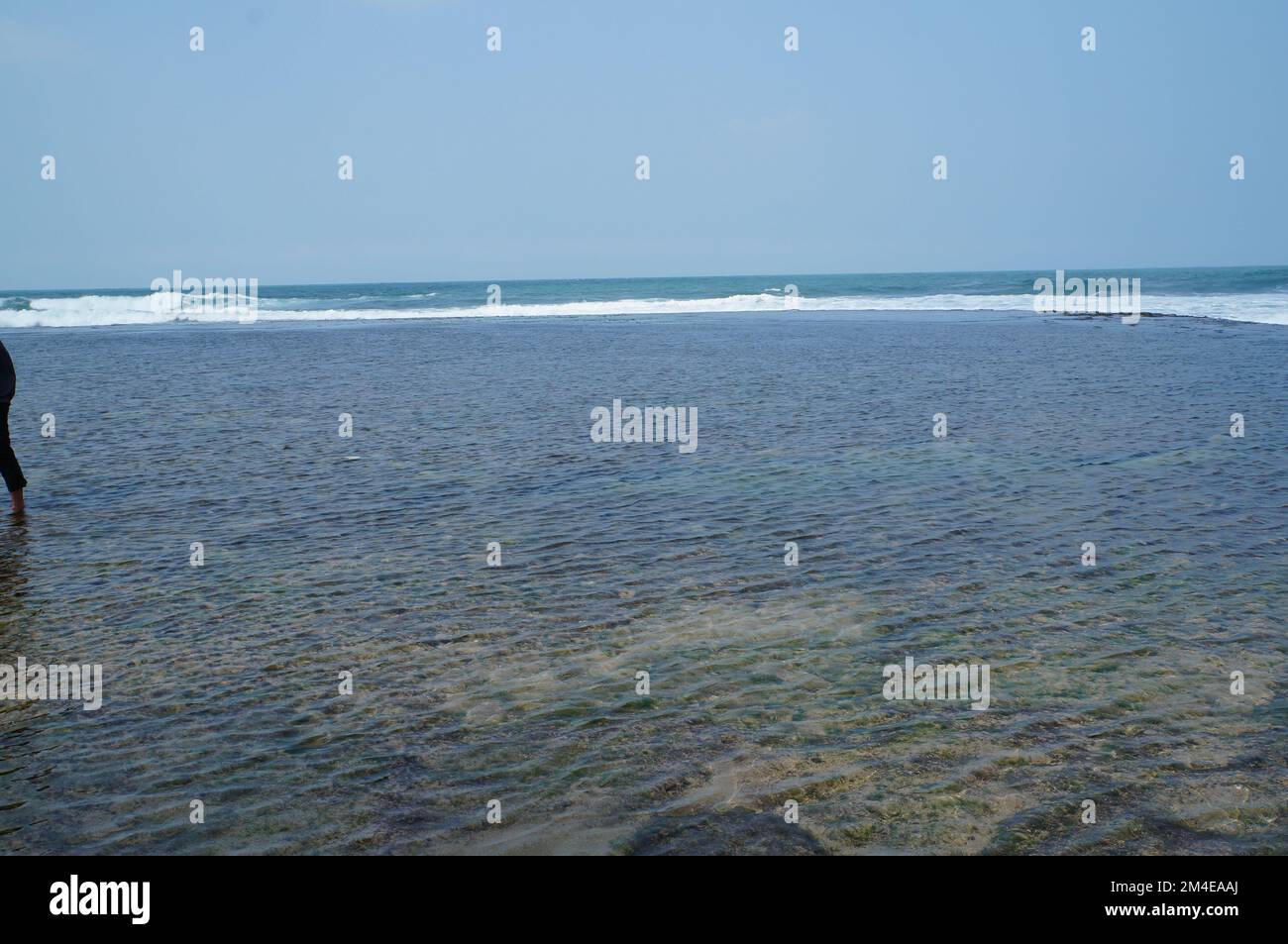 Beautiful sea water waves in Indonesia against a blue sky background ...