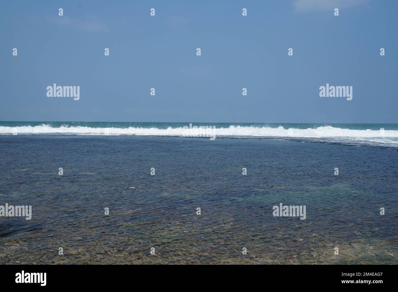 Beautiful sea water waves in Indonesia against a blue sky background ...