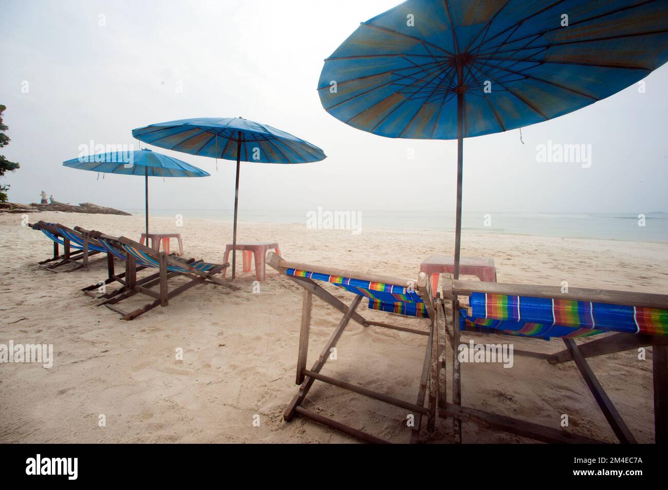 Umbrellas and bed rest on the beach Stock Photo - Alamy