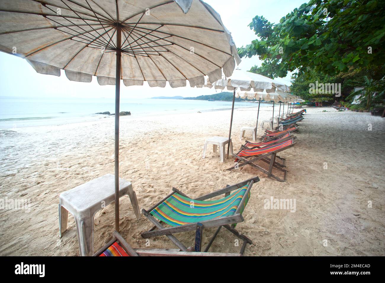Umbrellas and bed rest on the beach Stock Photo - Alamy