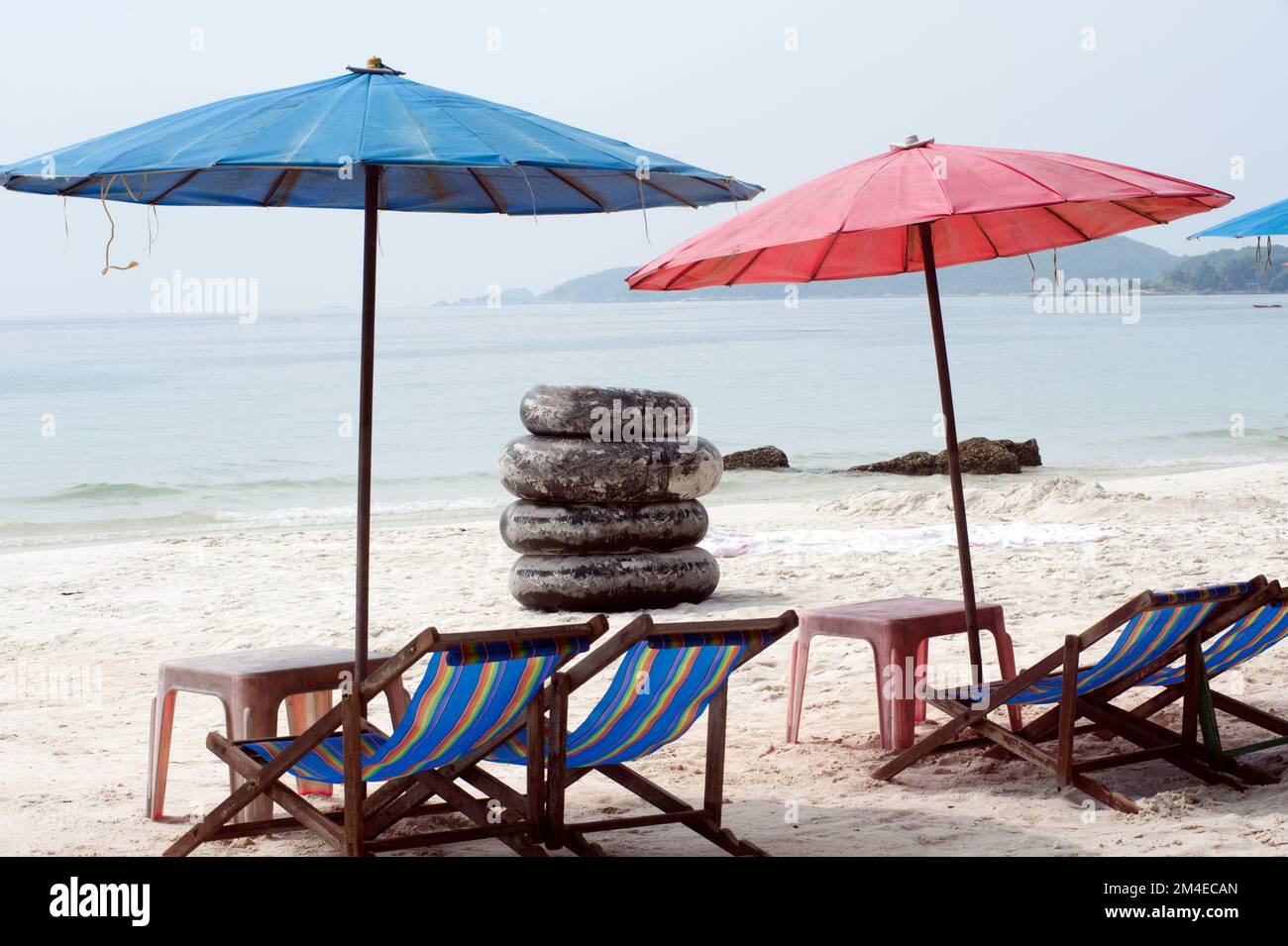 Umbrellas and bed rest on the beach Stock Photo - Alamy