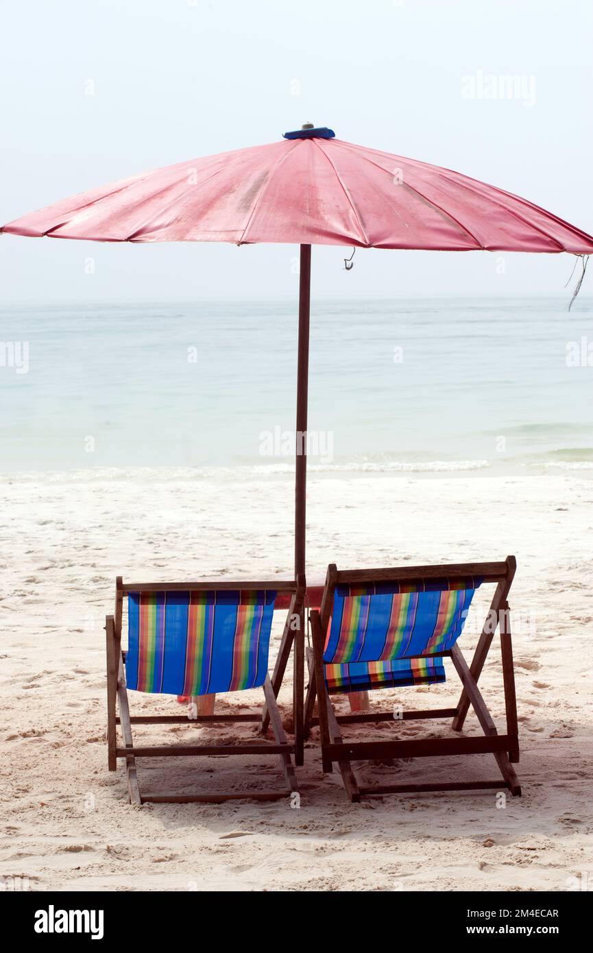 Umbrellas and bed rest on the beach Stock Photo - Alamy