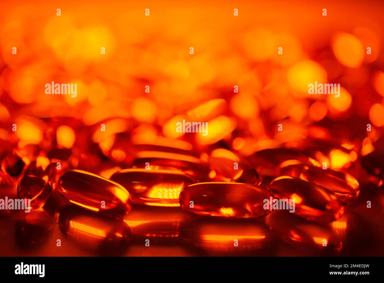 Fish Oil capsules with Omega 3 Macro Backlit Glowing Orange Background ...