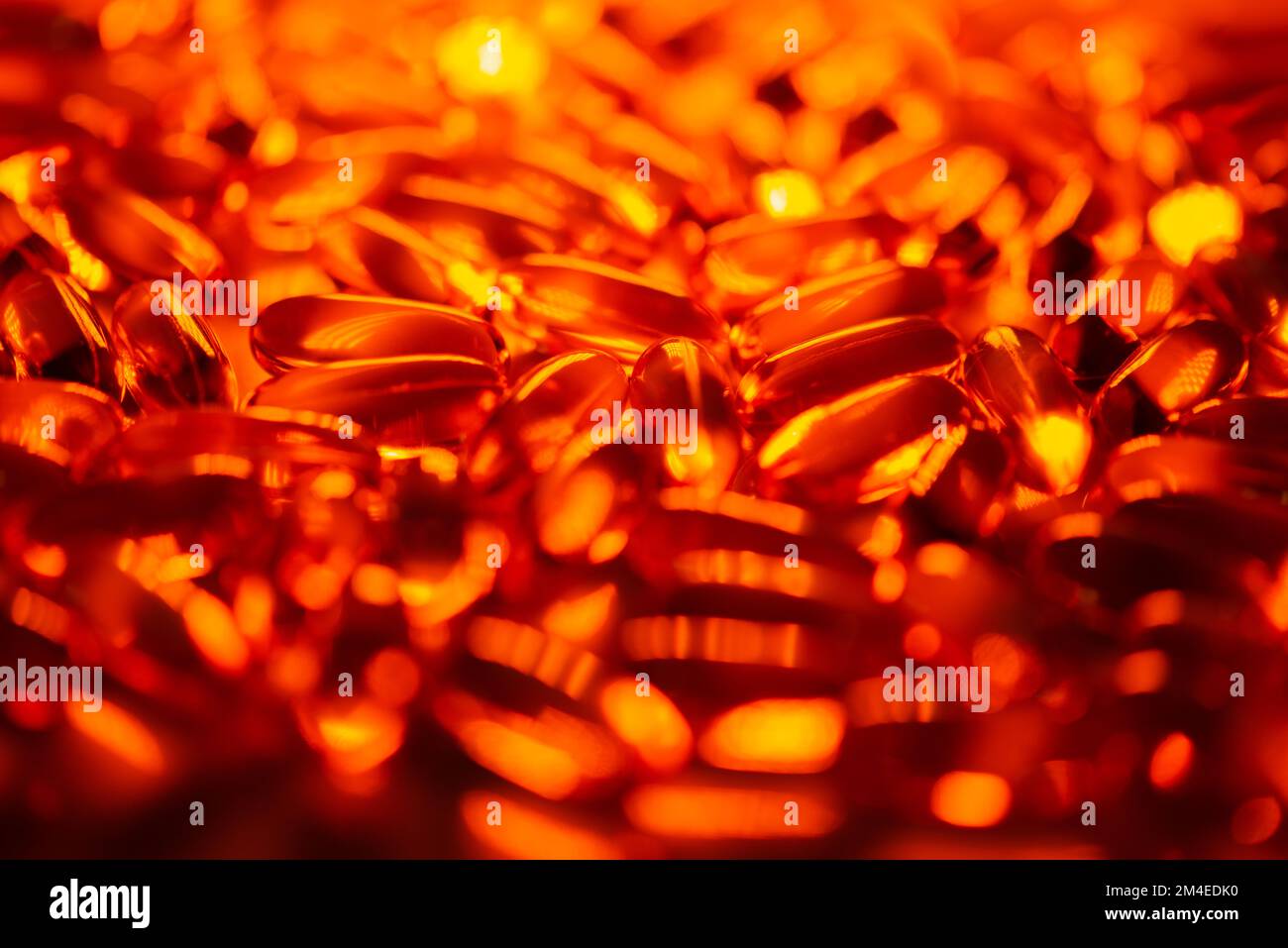 Fish Oil capsules with Omega 3 Macro Backlit Glowing Orange Background ...