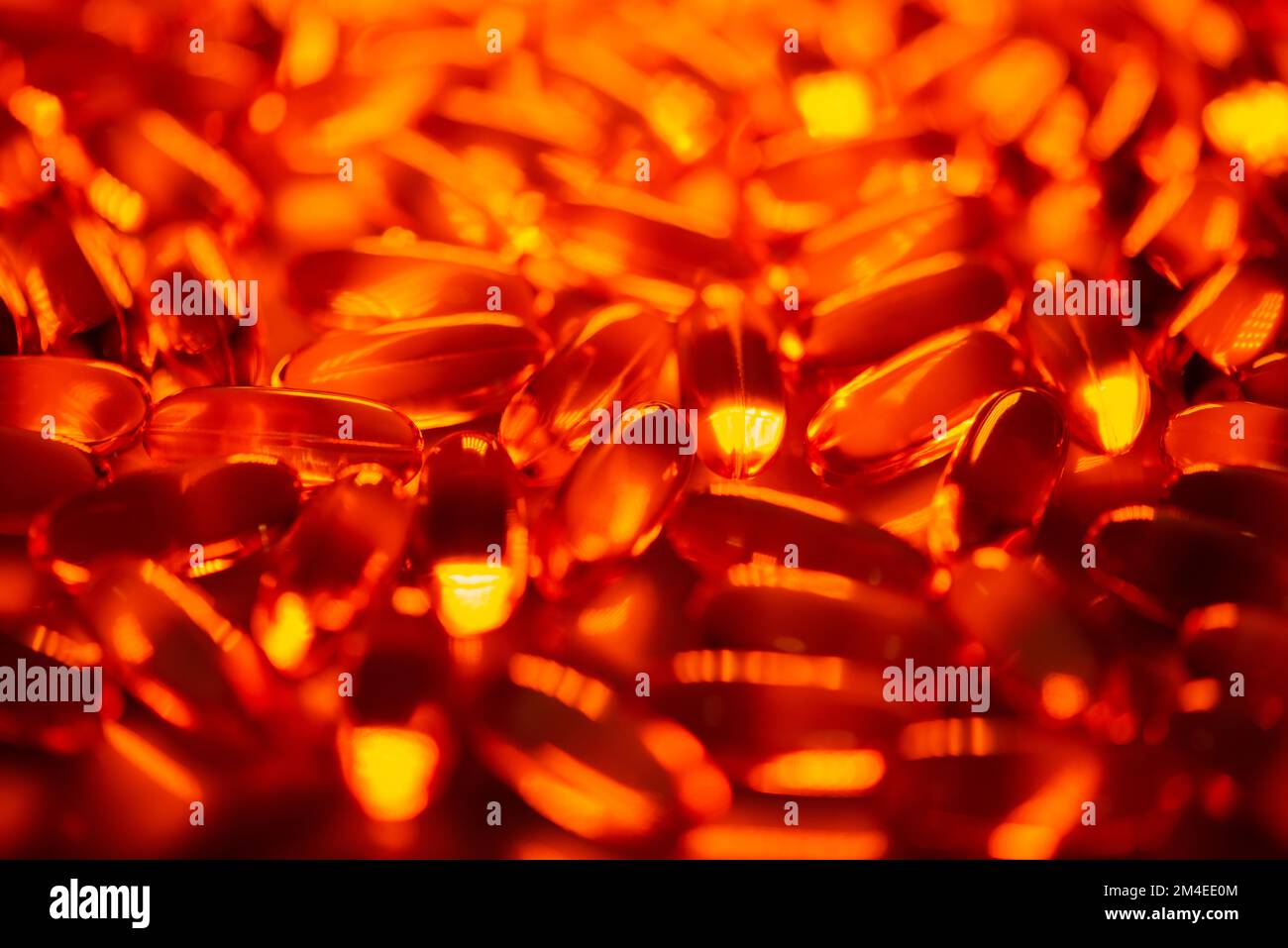 Fish Oil capsules with Omega 3 Macro Backlit Glowing Orange Background ...