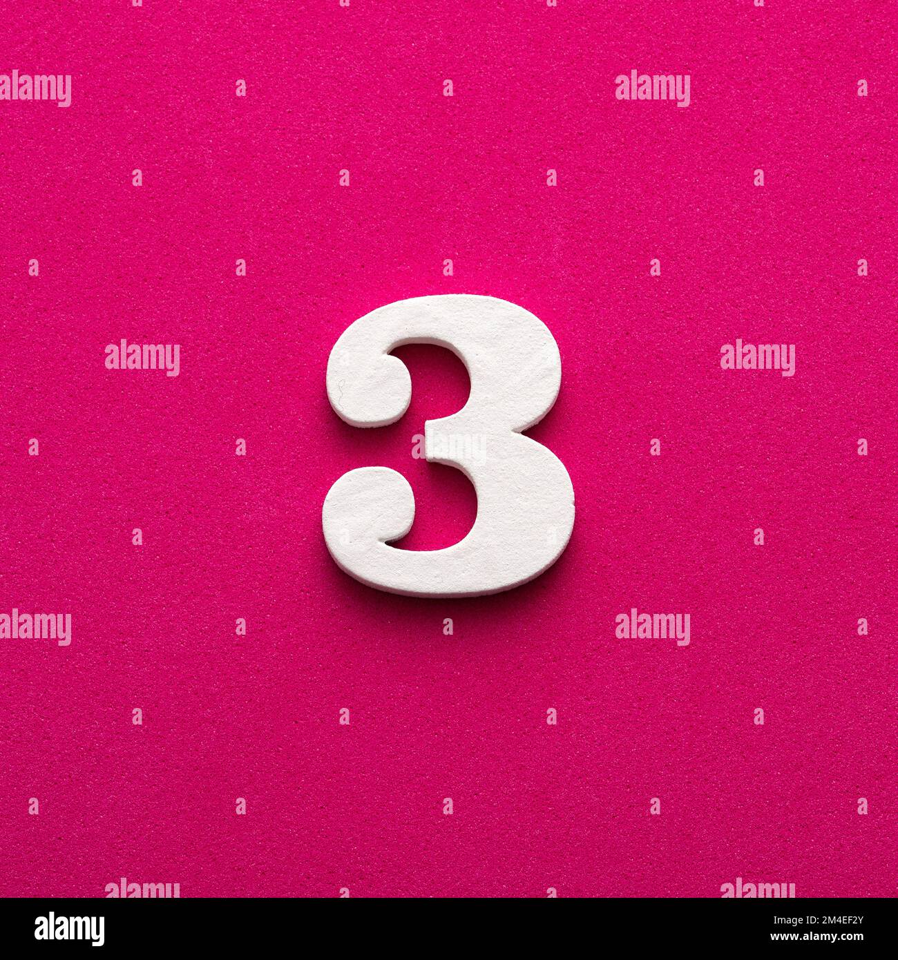 Number three - white number in wood on rhodamine red background Stock ...