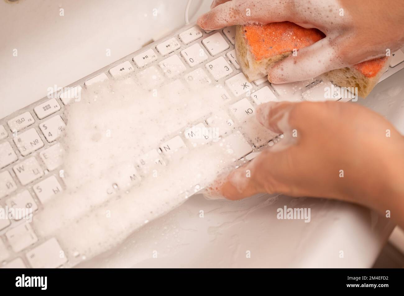 Woman washing white computer keyboard hi-res stock photography and ...