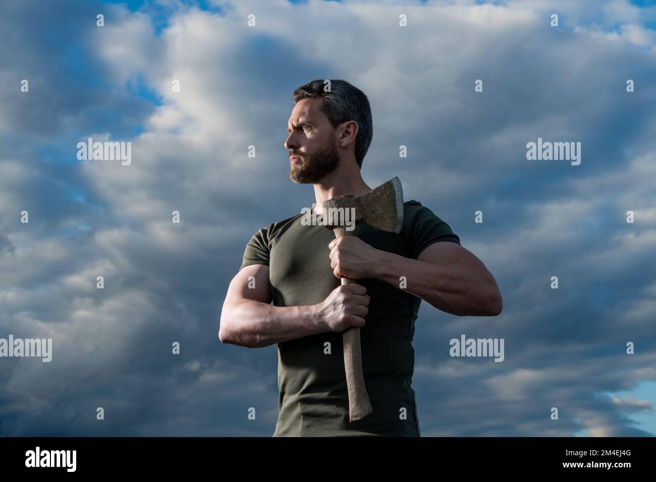 strong man with axe. craftsman man hold ax. brutal man on sky ...