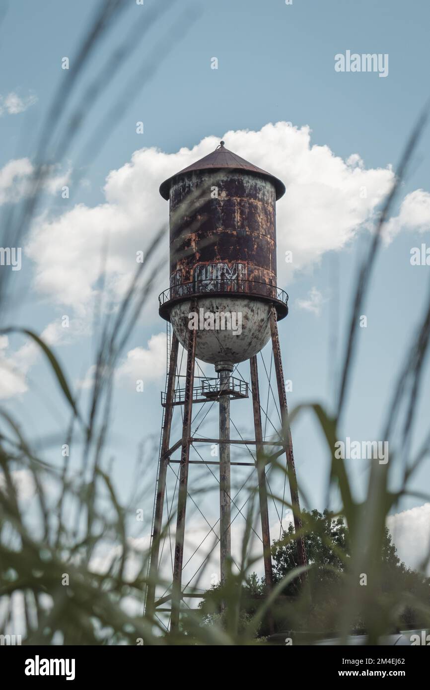 A beautiful vertical view of a rusty water tower in a field Stock Photo ...
