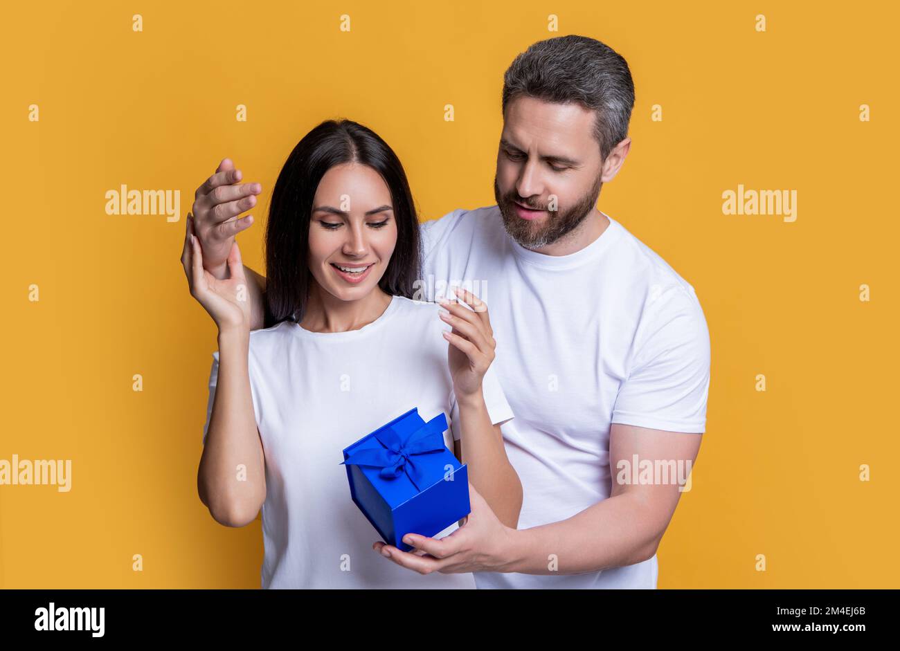 holiday couple with surprise blue present box. photo of couple with ...