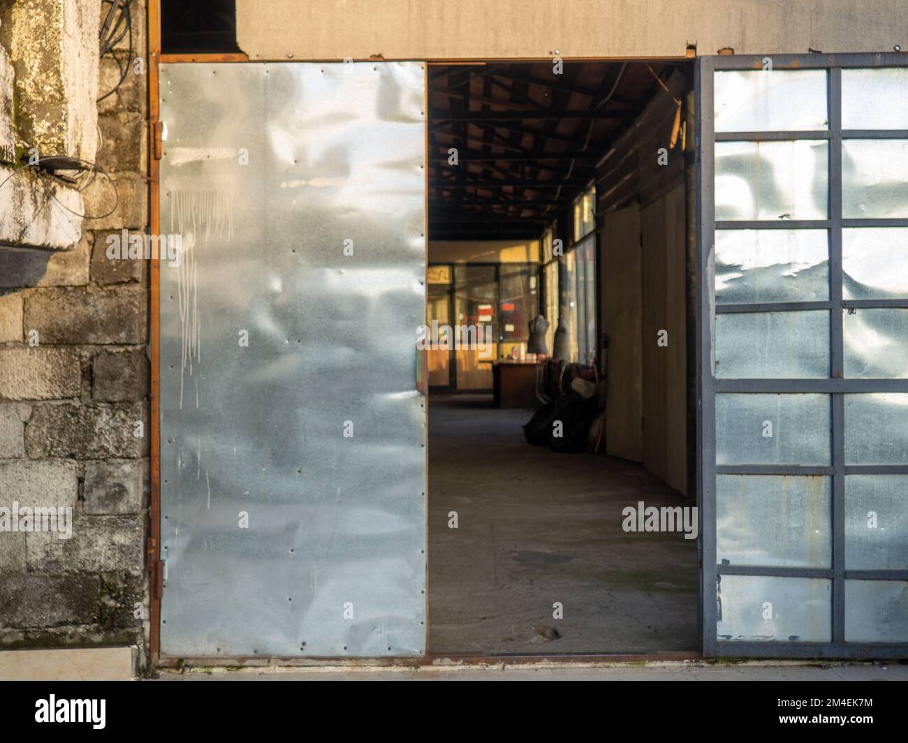 Open metal door. Double door. Entrance to a spacious room. Entrance to ...