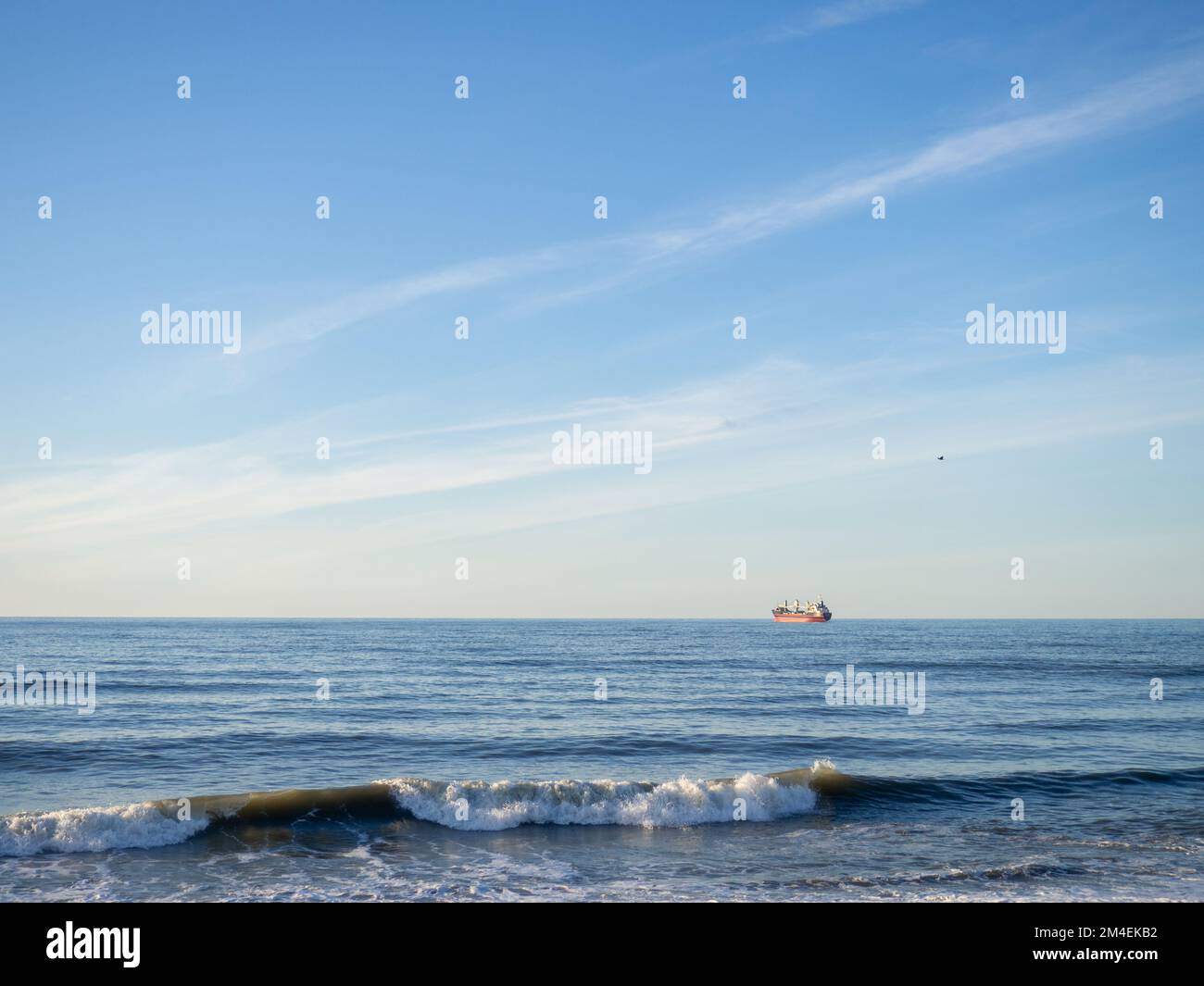 Industrial ship far out to sea. Landscape with a ship. Skyline. Sky and ...