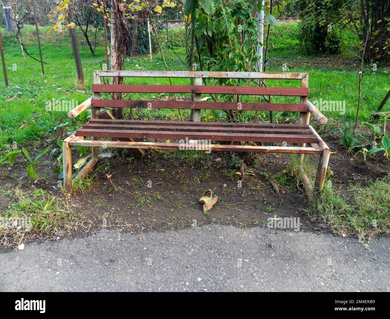 Empty old bench. Old courtyard. Bench made of metal and iron. abandoned ...