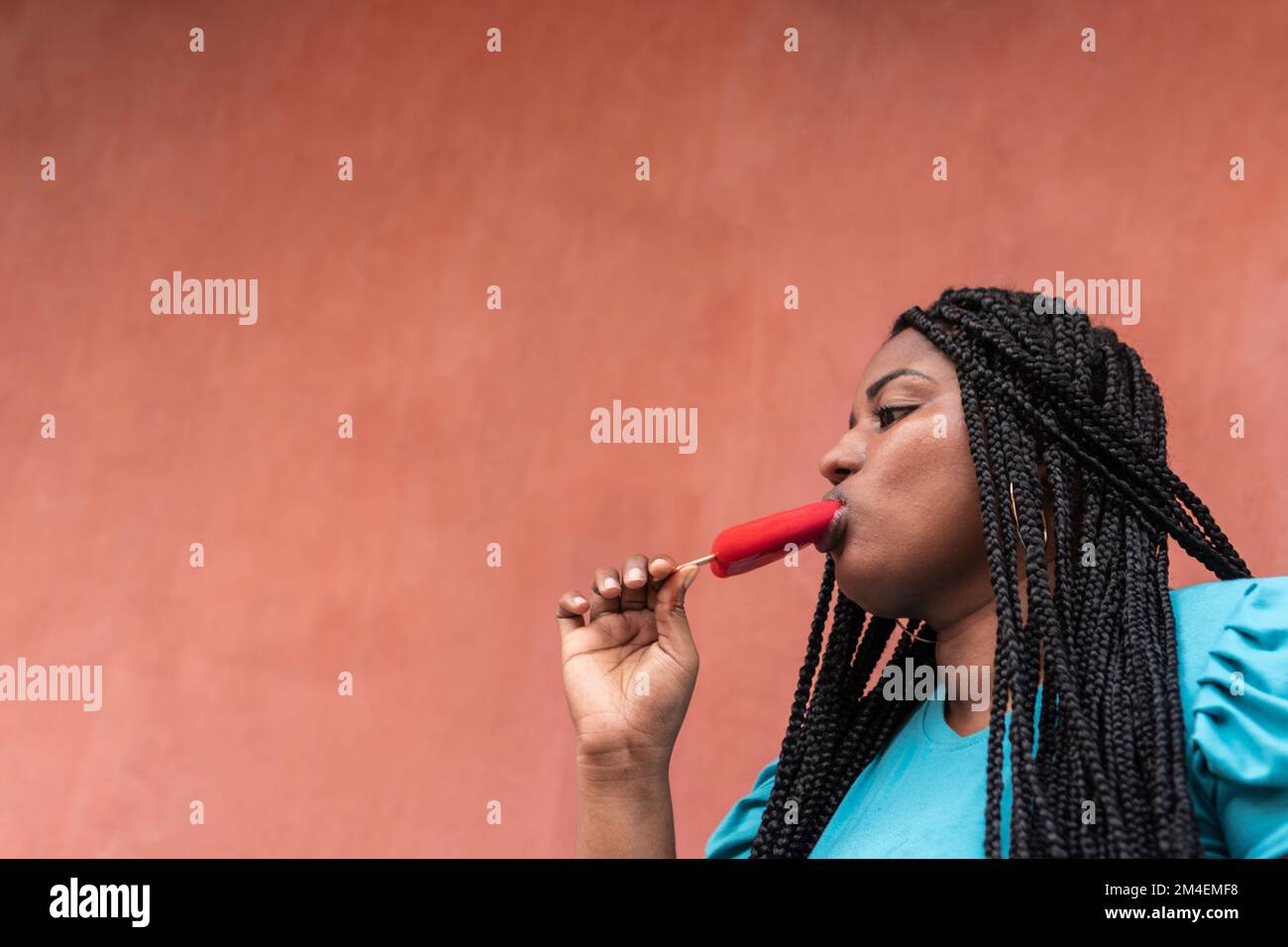 Young Black Woman Eating Popsicle In The City Stock Photo - Alamy
