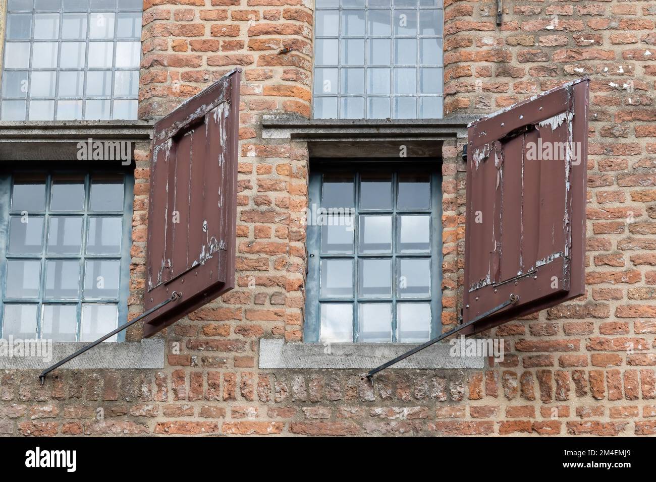 The facade of a brick building with old windows Stock Photo - Alamy