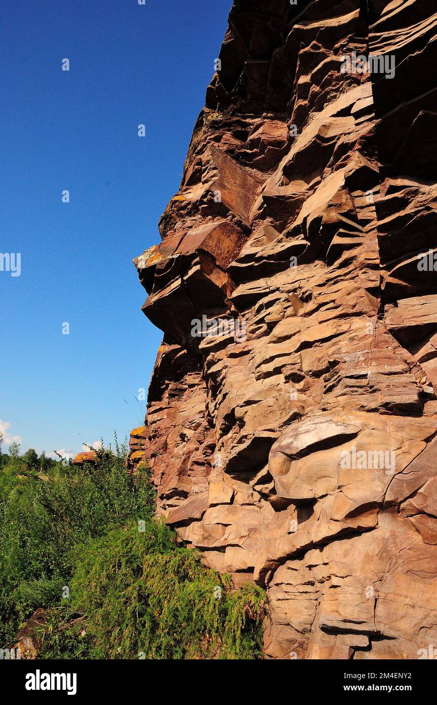 Ruins and remains of an ancient stone wall made of layered sandstone ...