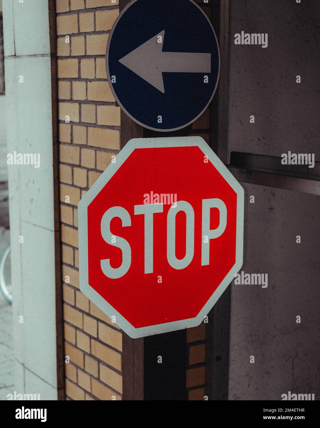 A vertical closeup shot of a Stop sign and one-way sign put on a ...
