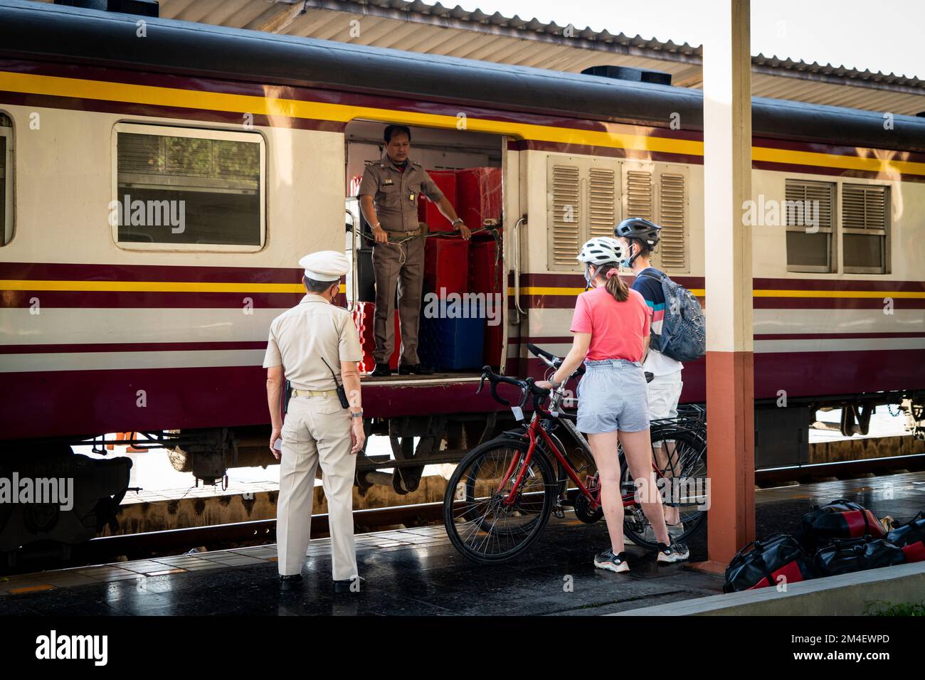 Travelers load their bicycles into the cargo car before boarding the ...