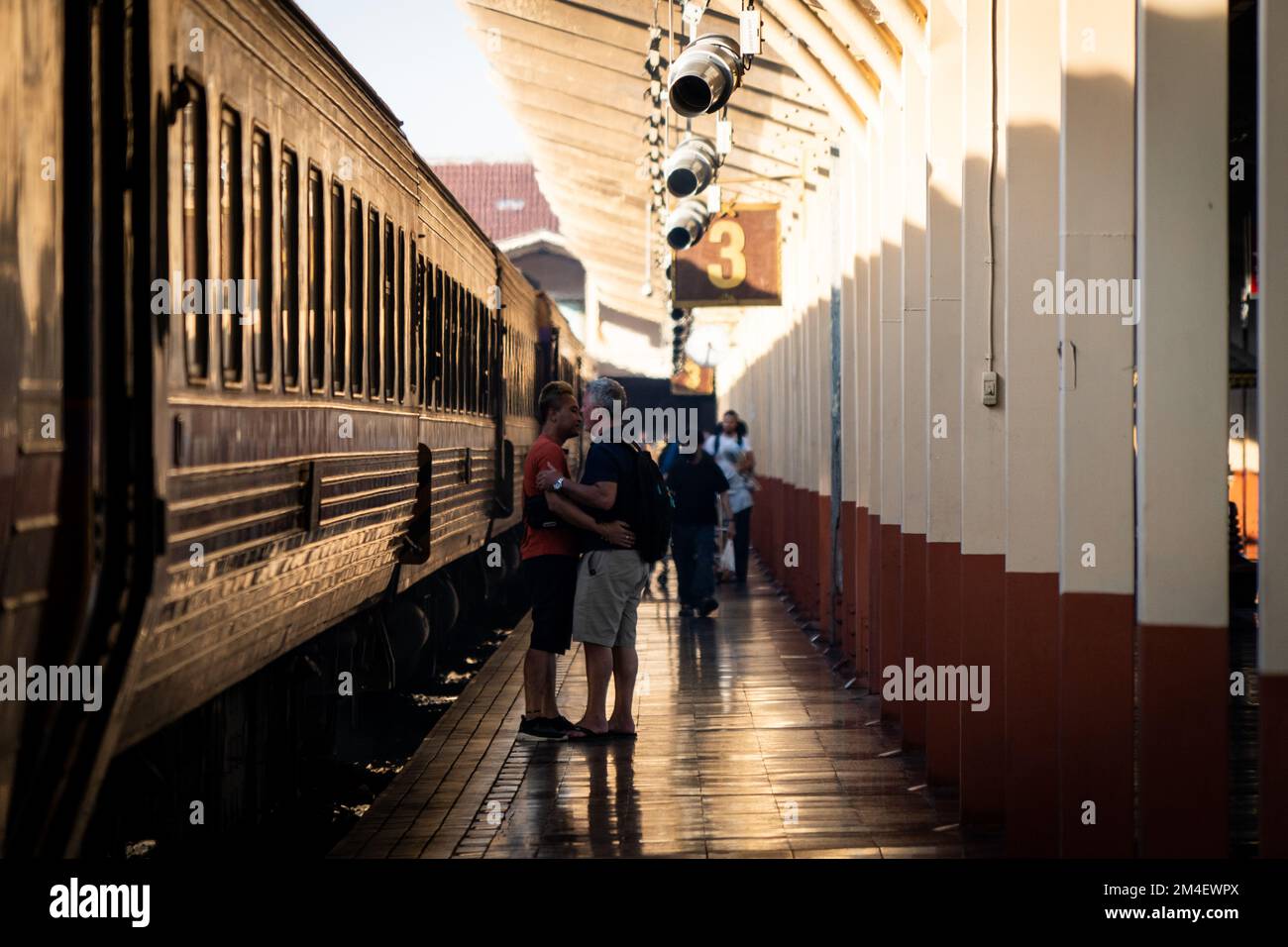 People embrace before the train departs from Chaing Mai Railway Station ...
