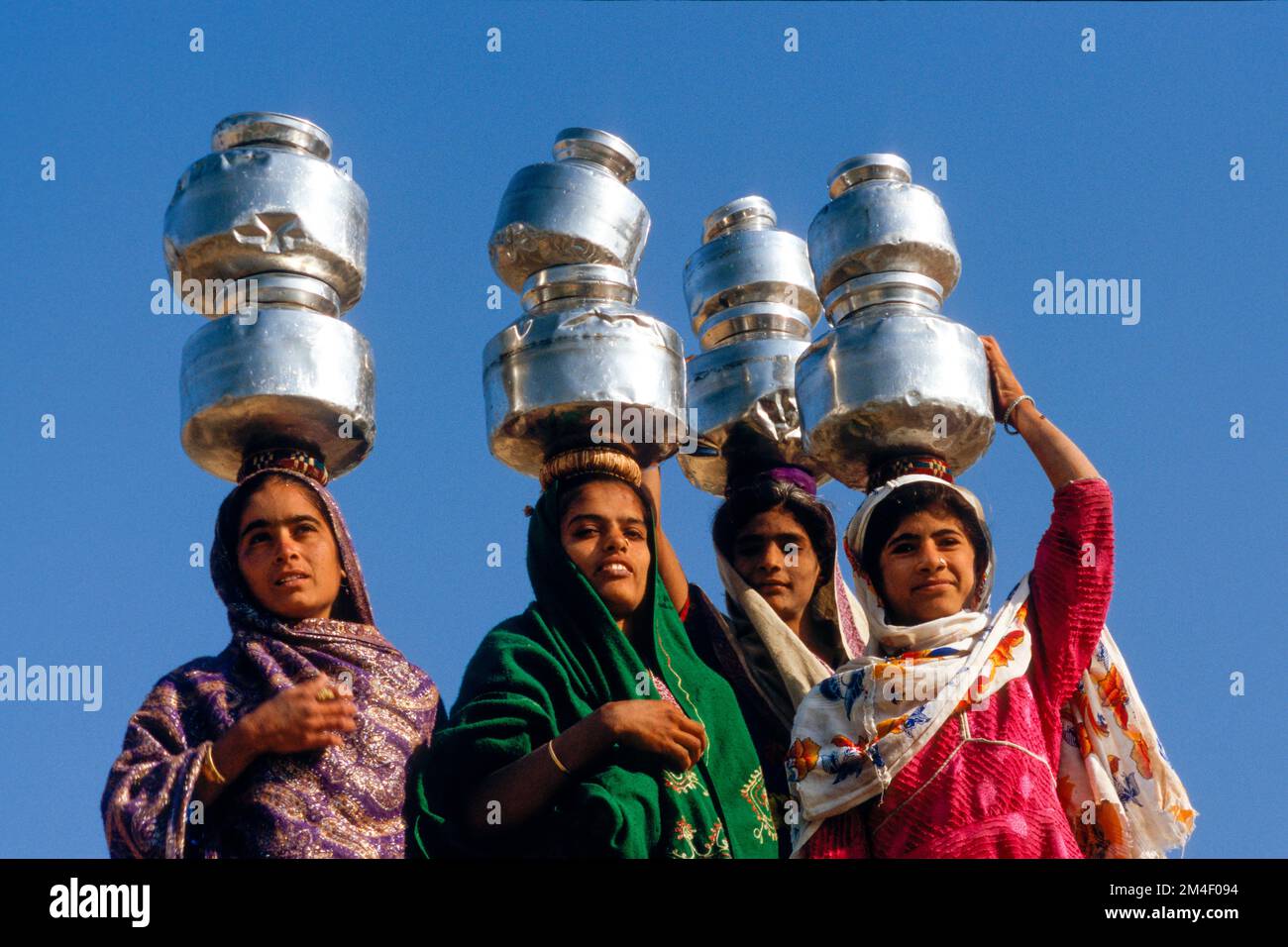 Women still have to carry water from the well to their houses Stock ...