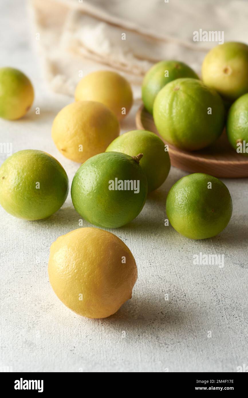 limes scattered on white table top, high in vitamin c, antioxidant and ...