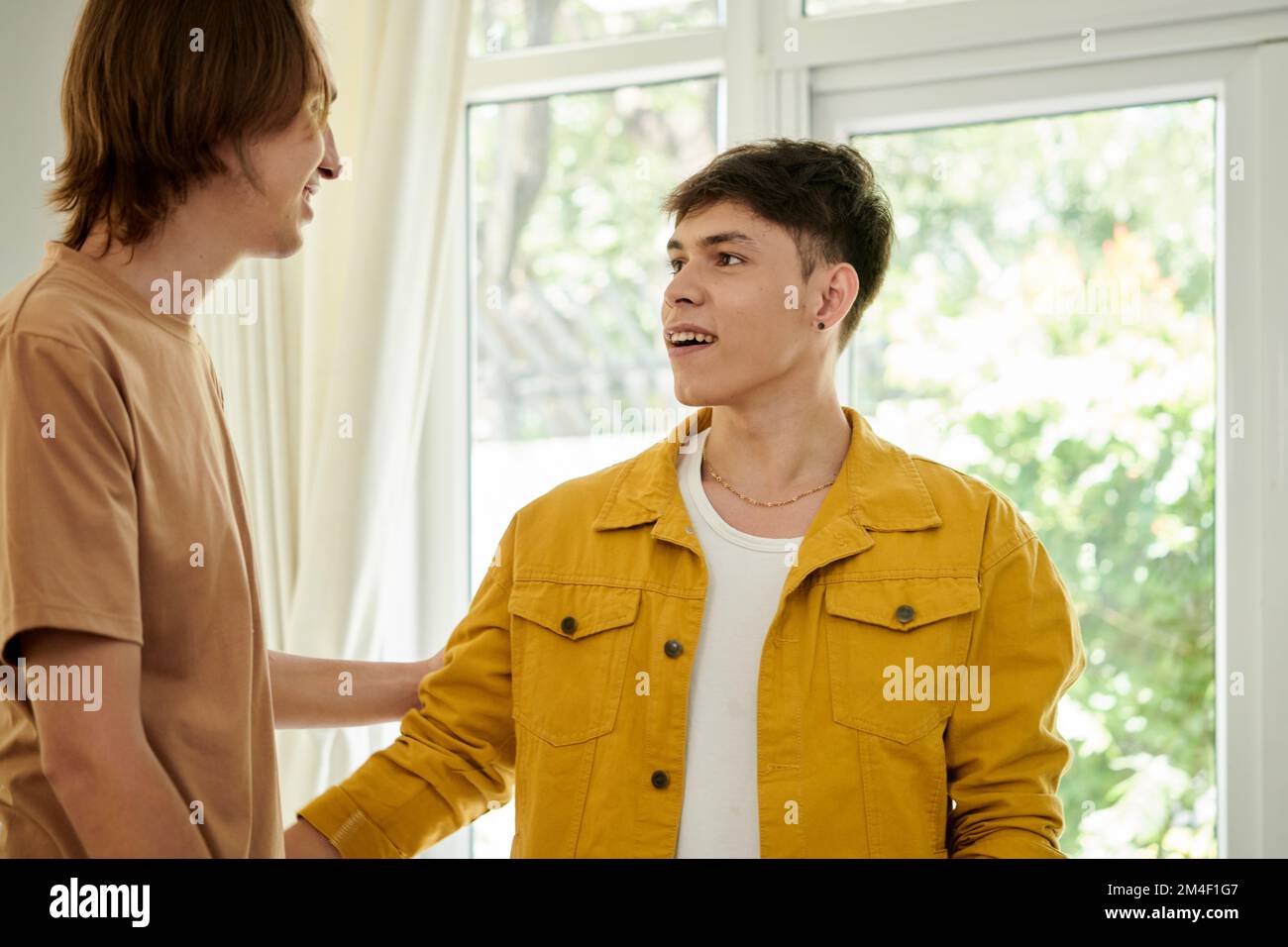 Joyful best friends taking to each other after summer vacation spent ...