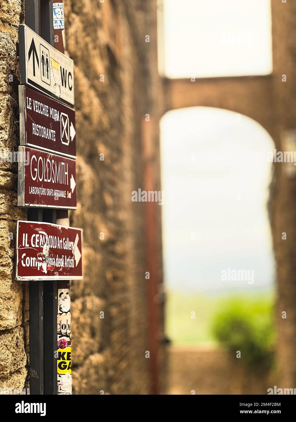 A vertical closeup of a post sign with directions to different ...