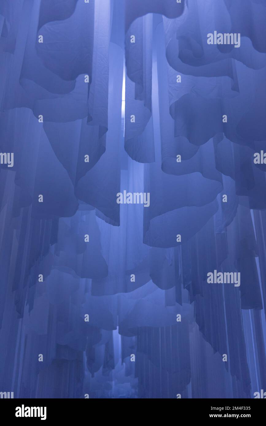 A vertical shot of a blue billowy hanging fabric creating dreamy ...