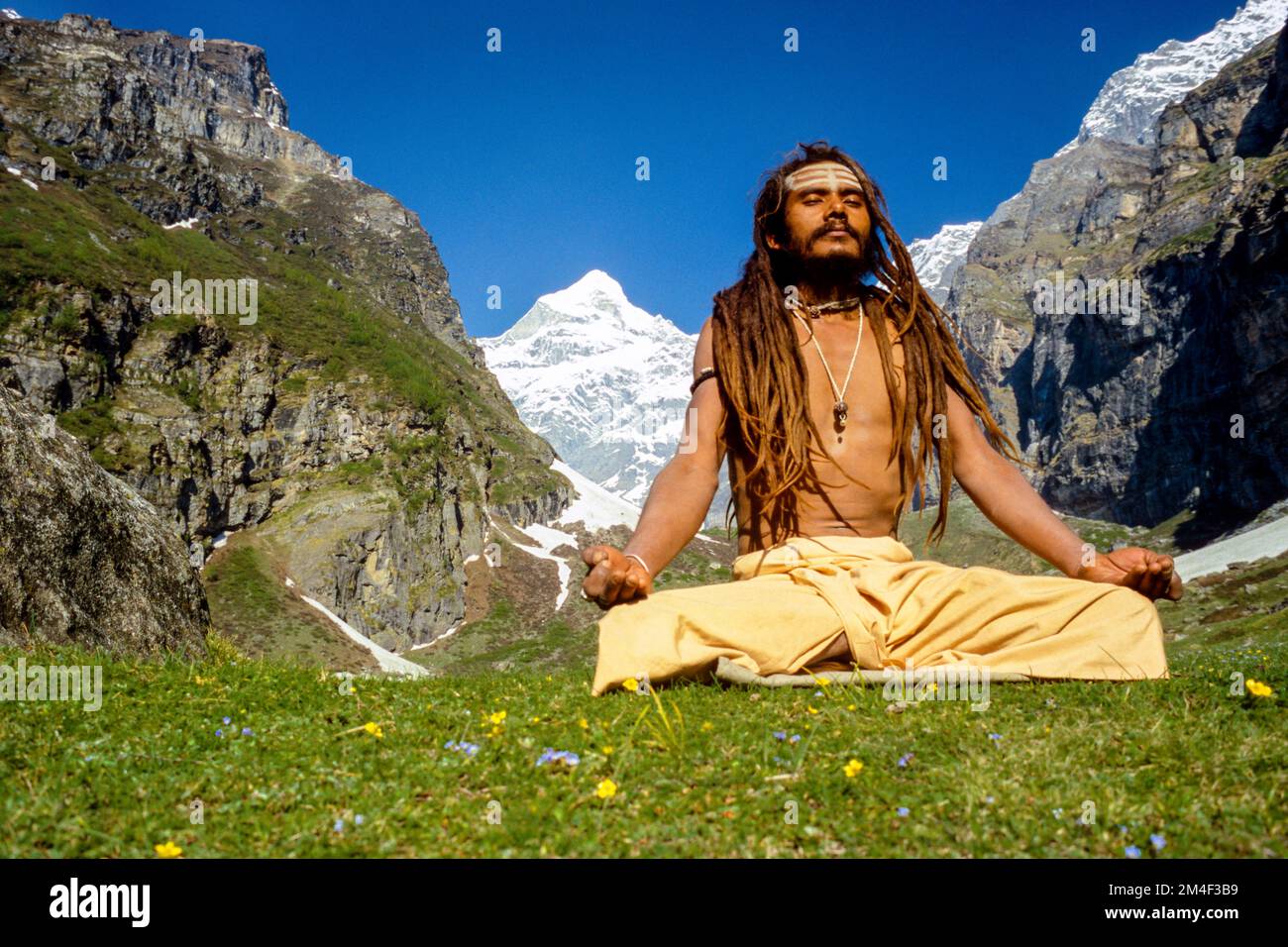 Shiva-Sadhu meditating next to his cave high above Badrinath Stock ...