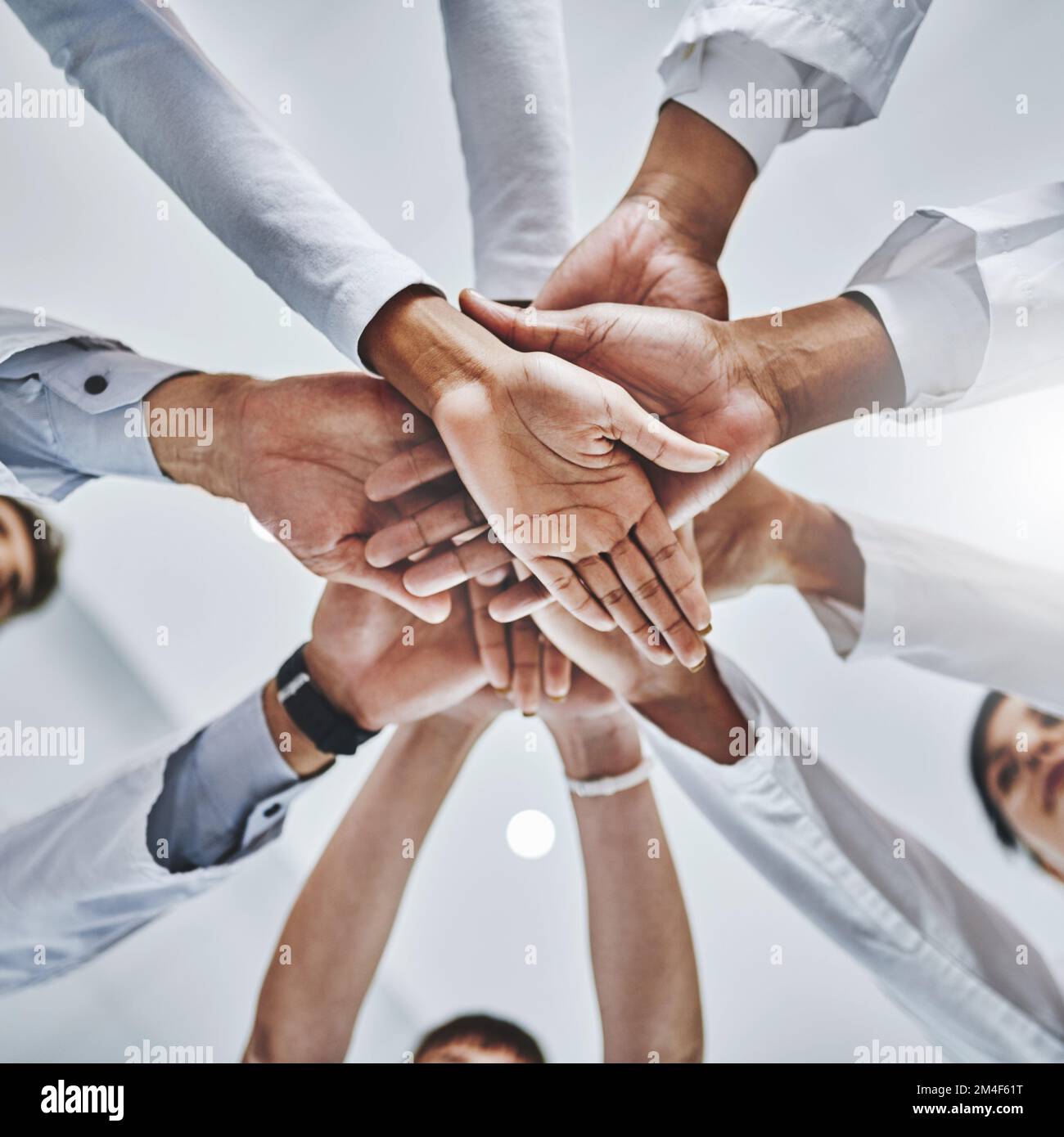 Diverse people team joining hands hi-res stock photography and images ...