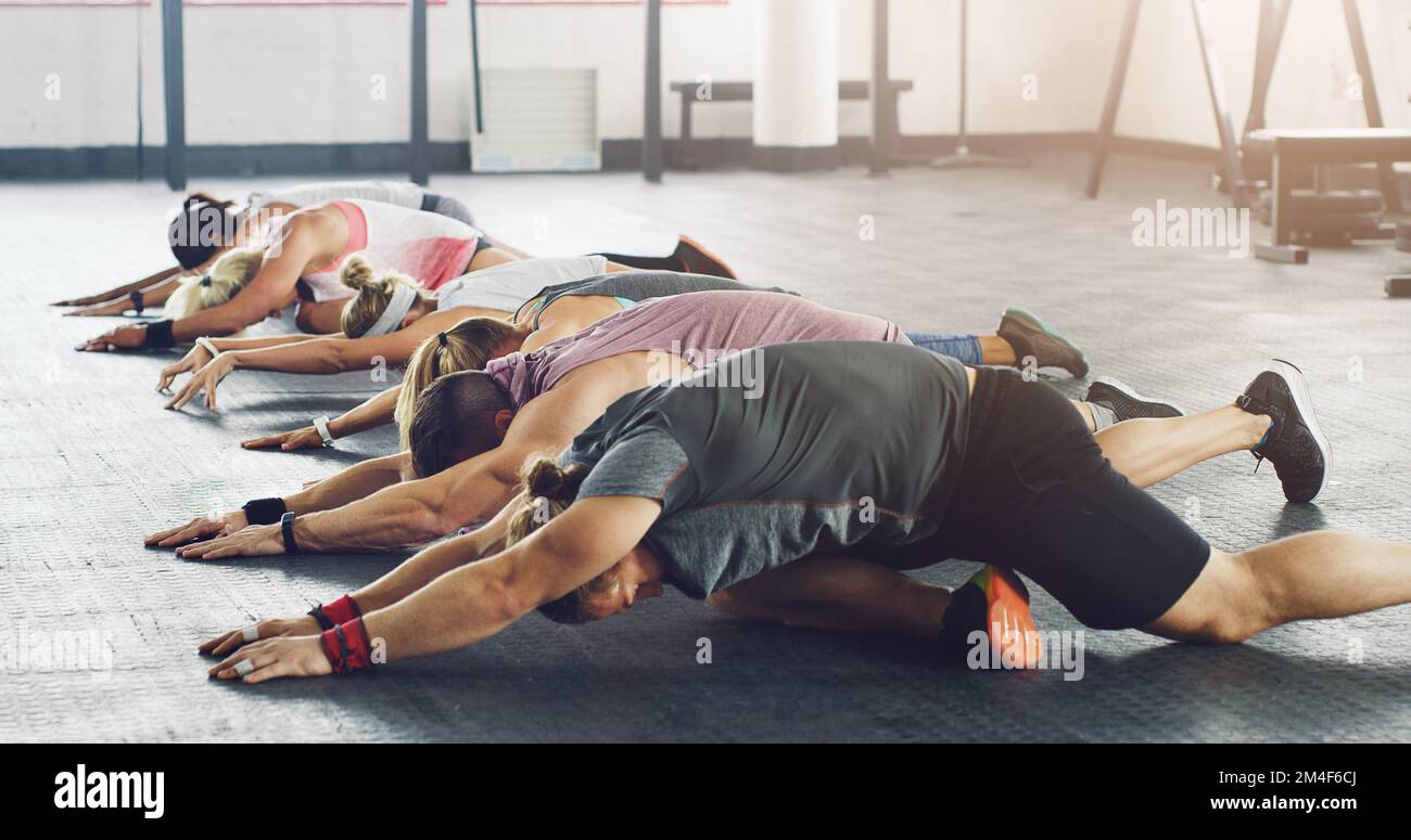 Bow down to the fitness gods at the workout temple. a group of young ...