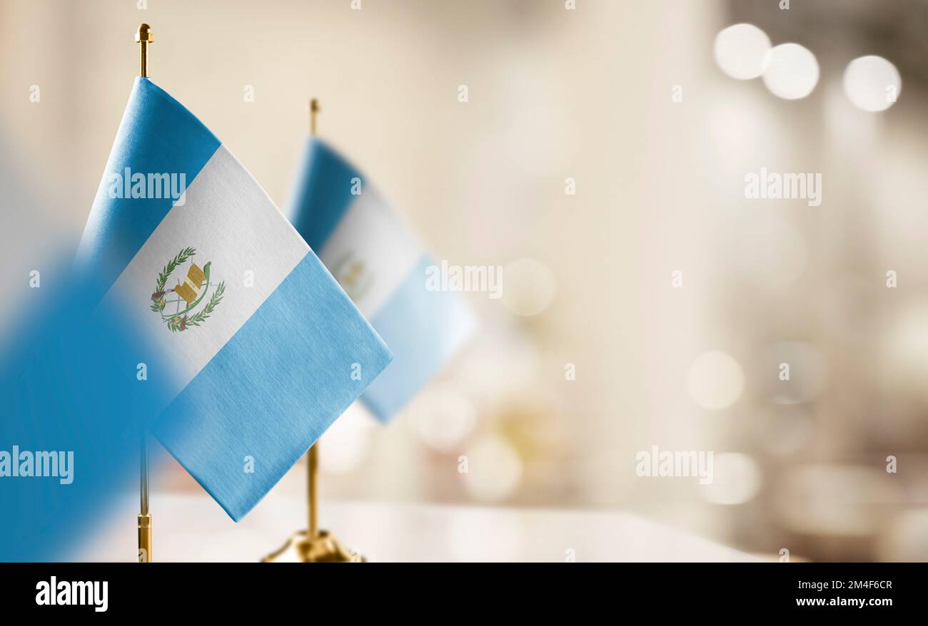 Small flags of the Guatemala on an abstract blurry background Stock ...