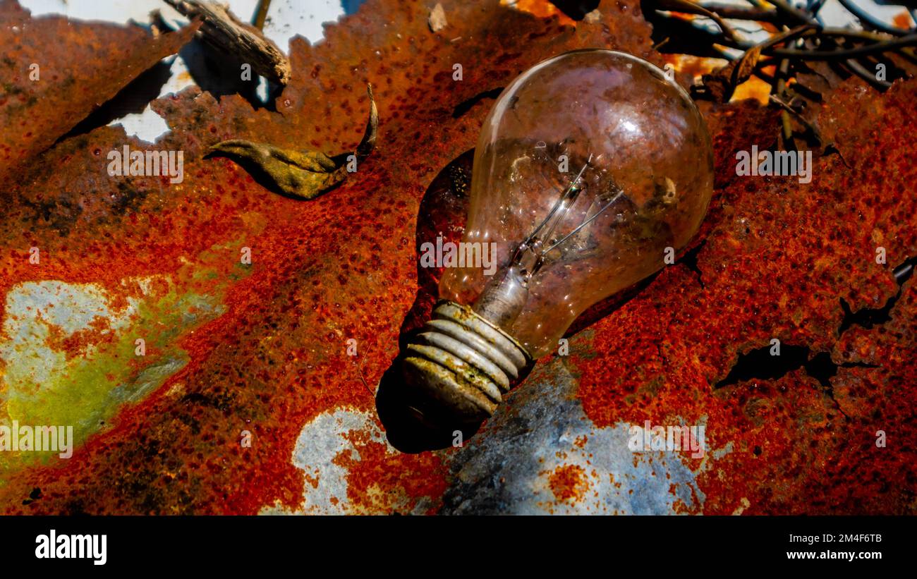 Light bulb on rusty zinc as background Stock Photo - Alamy