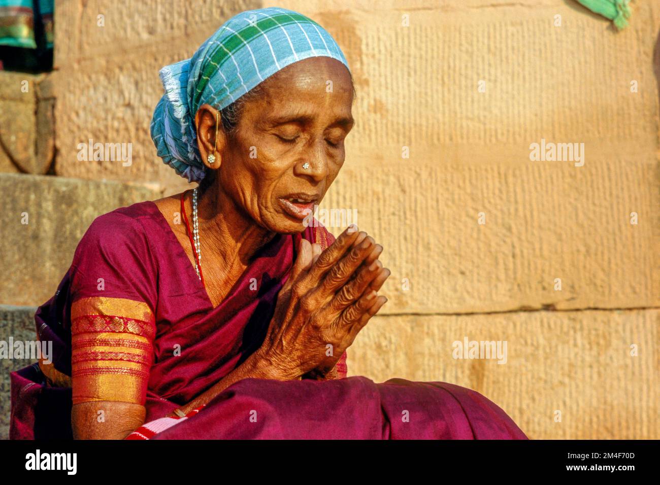 Woman praying to the Godess Ganga. Religion is a big part of daily live ...