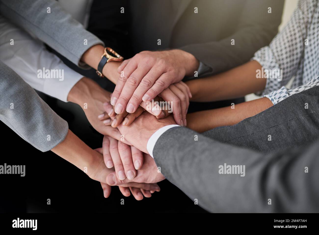 Teamwork makes things happen. a group of colleagues joining hands in ...