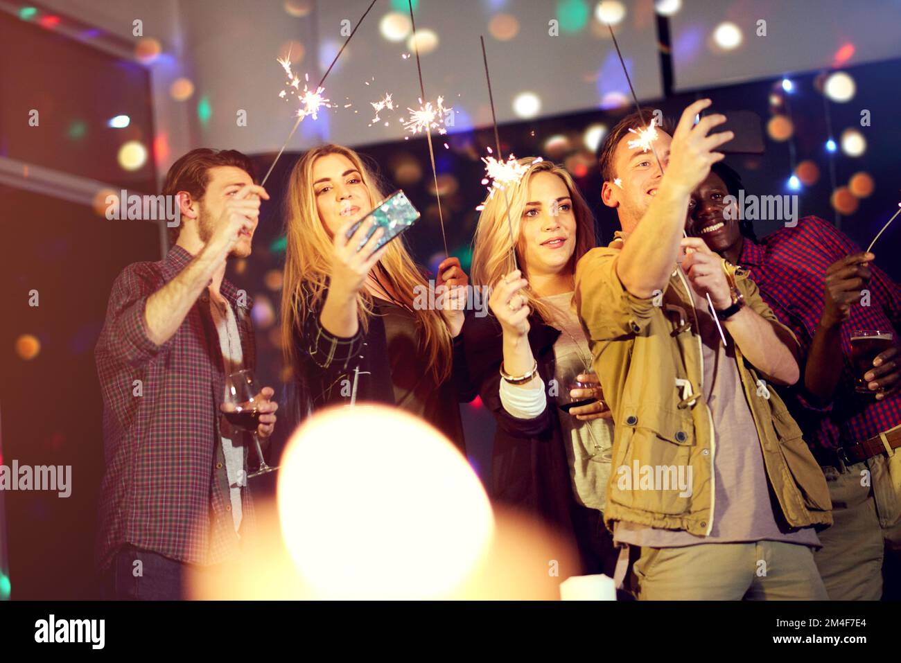 We have to take a selfie with these sparklers. a group of friends ...