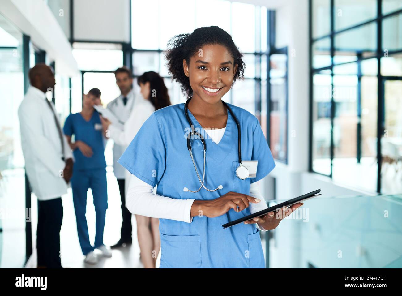 The best tool a modern doctor could have. Portrait of a young doctor ...