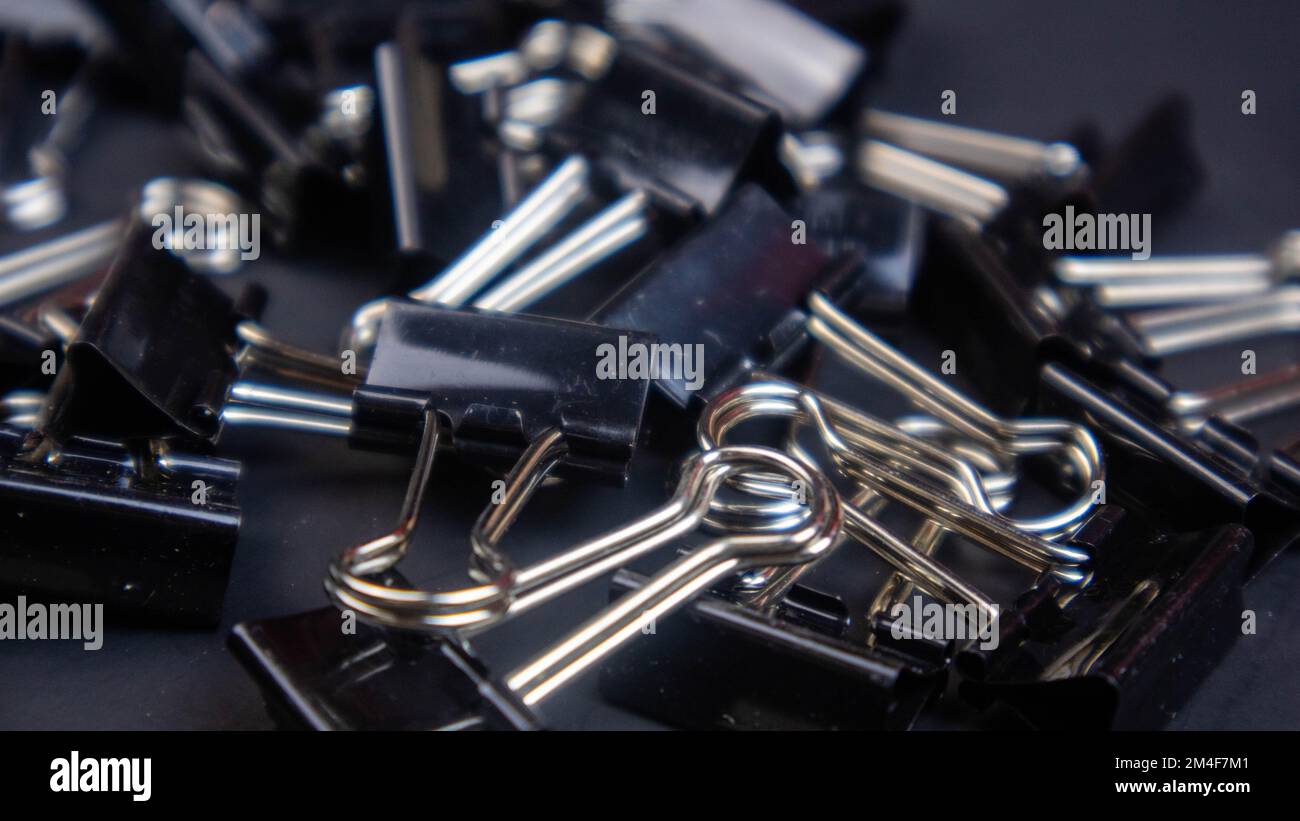 black paper clip on black background Stock Photo - Alamy