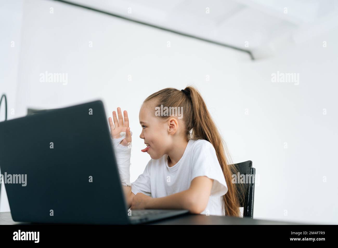 Adorable little girl with broken hand wrapped in white plaster bandage ...