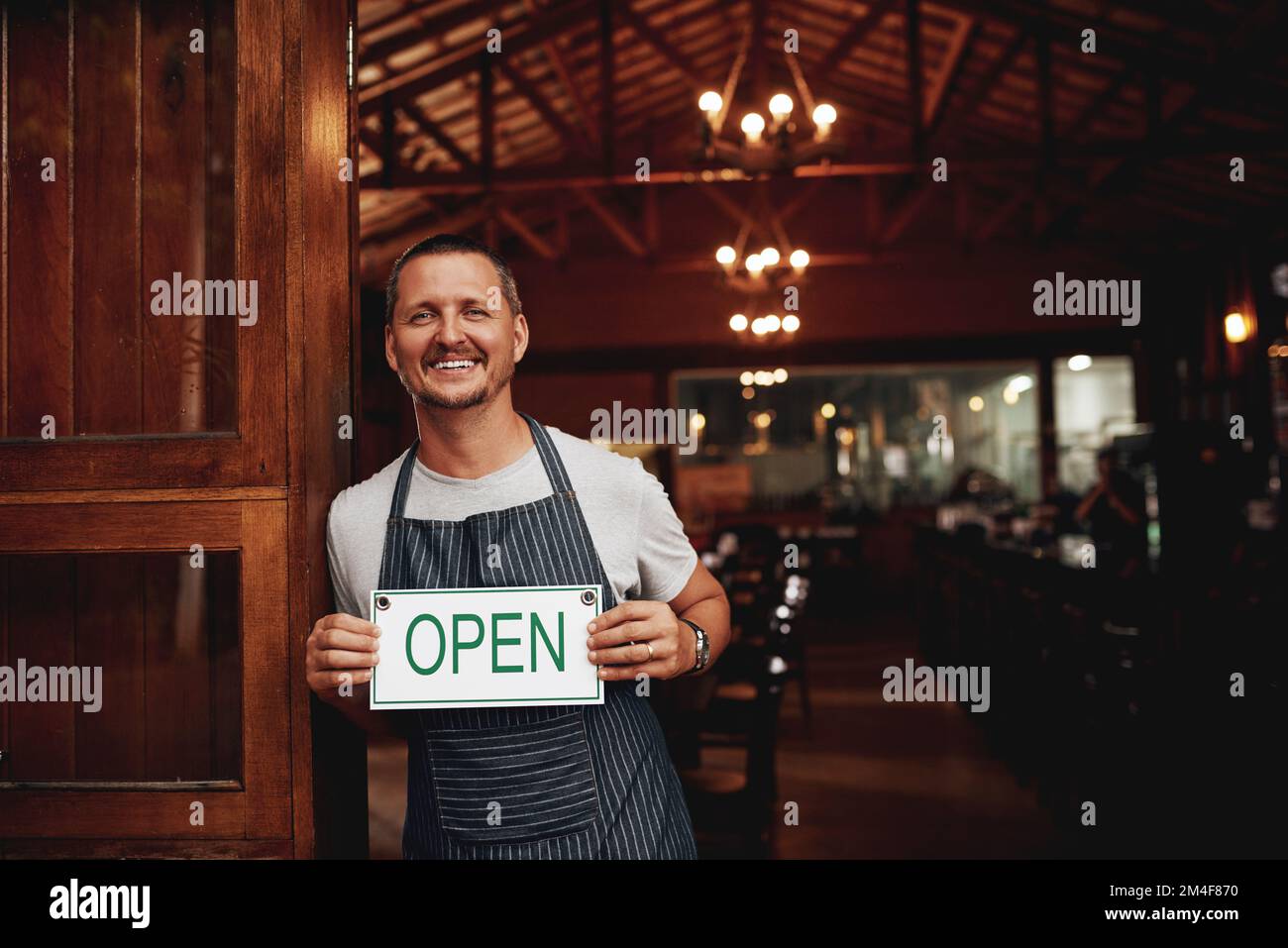 After a long wait we are officially open. Portrait of a cheerful middle ...