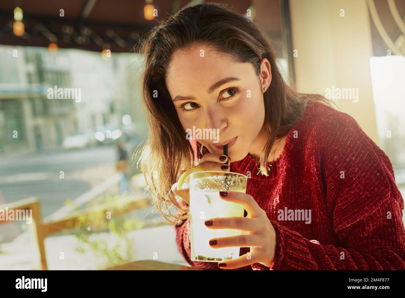 Every sip is so more-ish. a young woman enjoying a fresh beverage in a ...