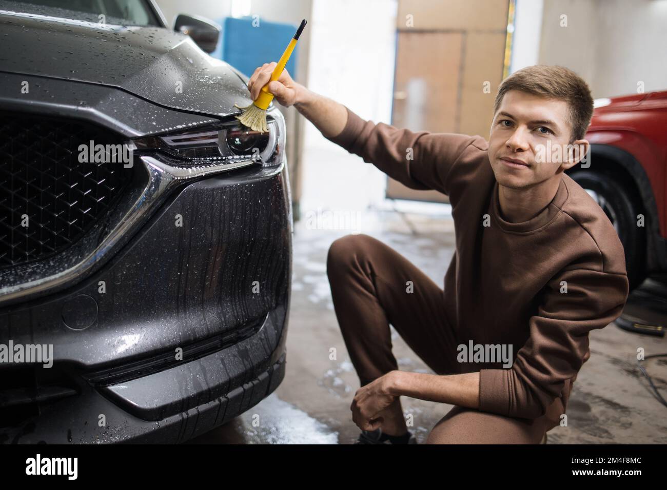 Car washing, detailing concept. Side view of caucasian man worker of ...