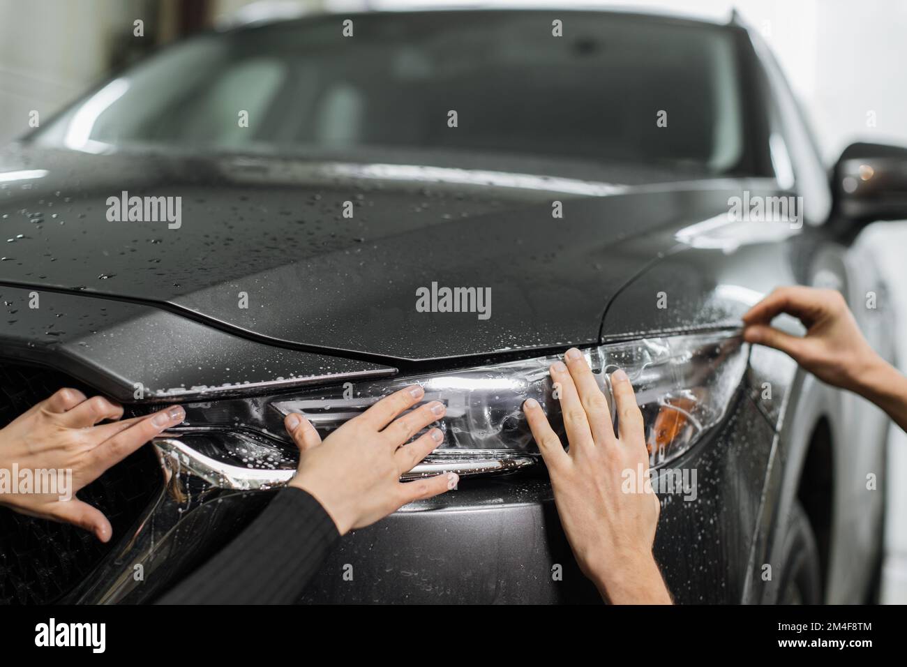 Close up to PPF installation process on a front headlight . PPF is a ...