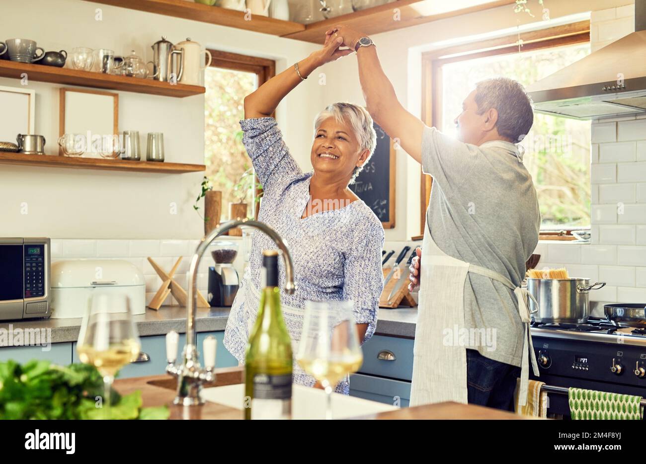 The kitchen was made for dancing. a happy mature couple dancing ...
