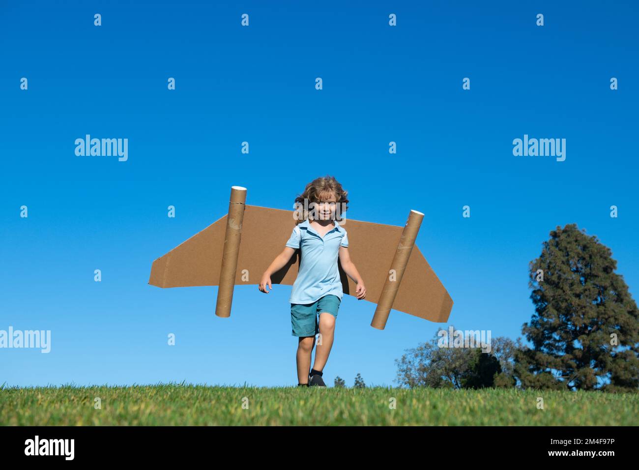 Dreams of travel. Child flying on jetpack with toy airplane on sky ...