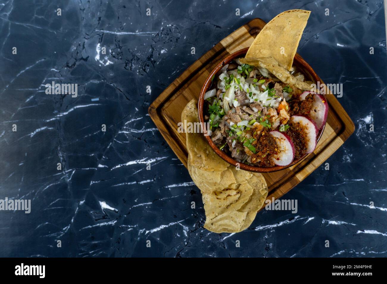 includes tatemada hot sauce, bacon, onion and cilantro on top ...